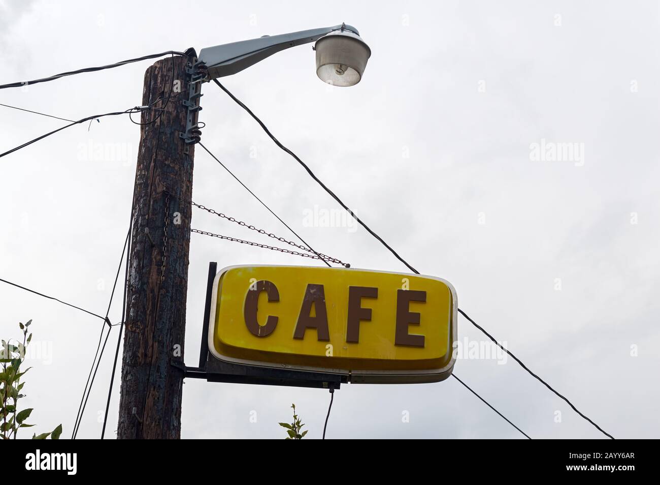 Cafe sign chained to a light pole Stock Photo - Alamy