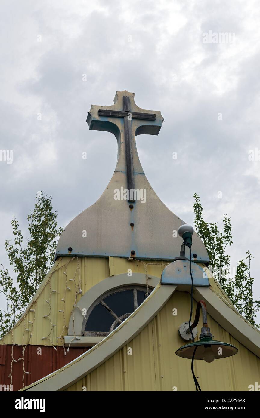 A cross sits atop a small church Stock Photo - Alamy