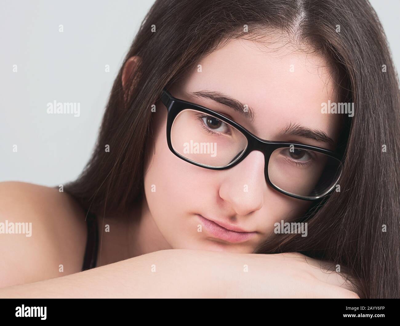 Portrait of a Serious Bespectacled Long-haired Brunette Teen Girl Stock ...