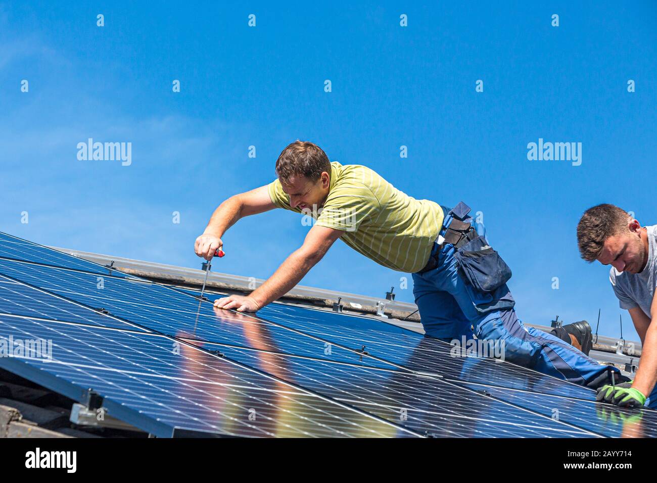 Installing solar photovoltaic panel system. Solar panel technician ...