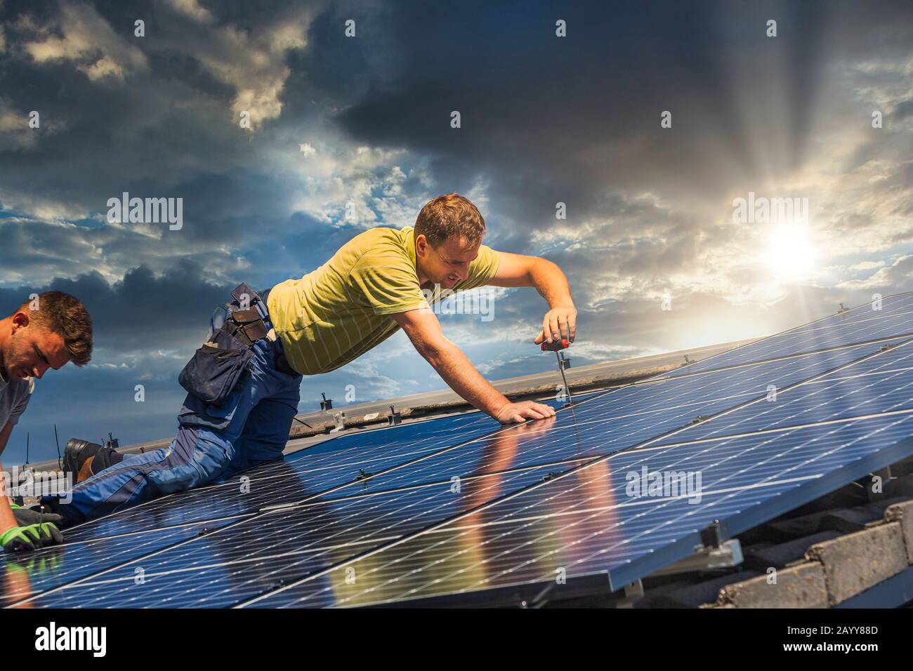 Portrait of workers installing photovoltaic panels on the roof Stock ...