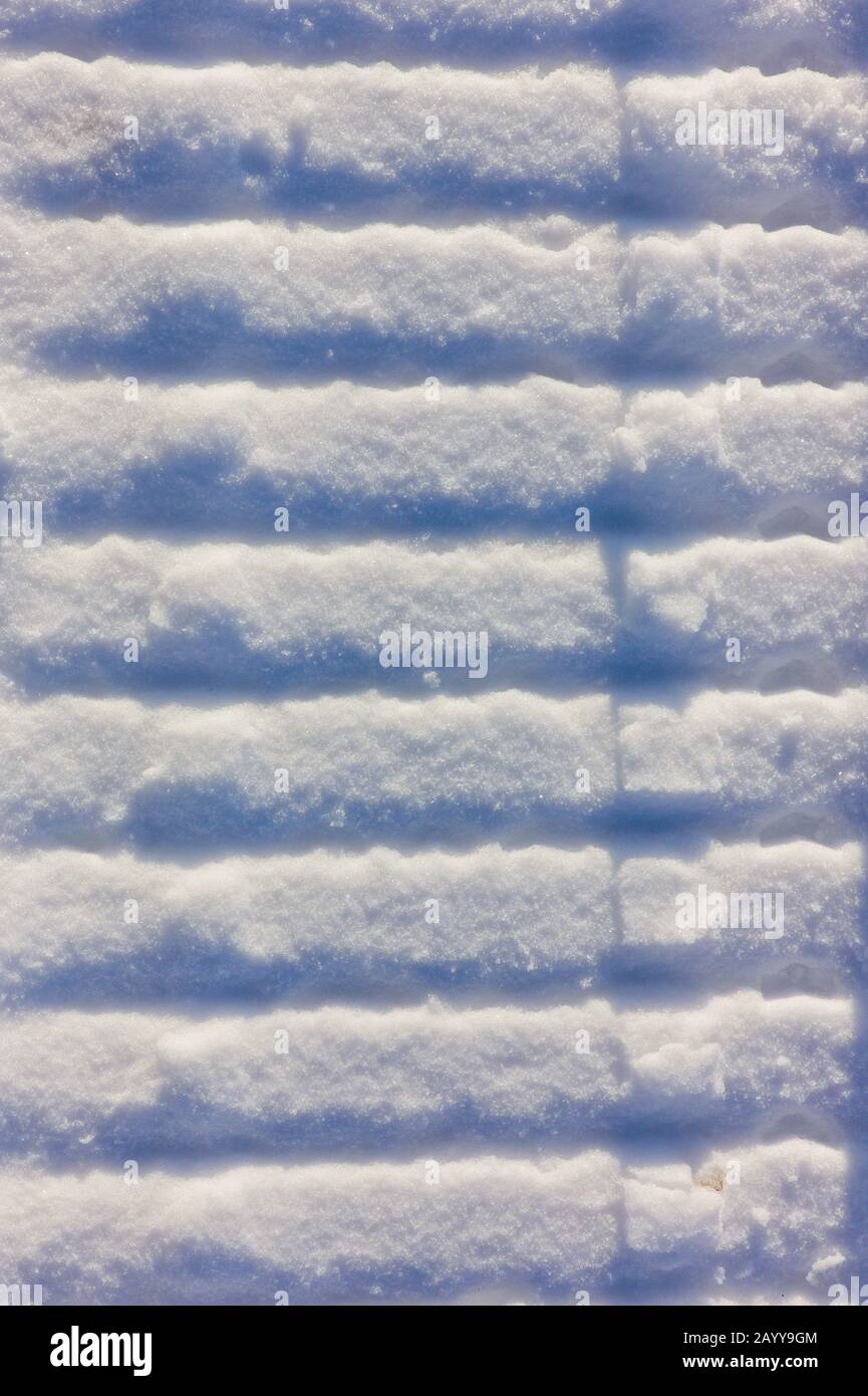 Snowmobile track on frozen river. Footprints in the snow on a ...