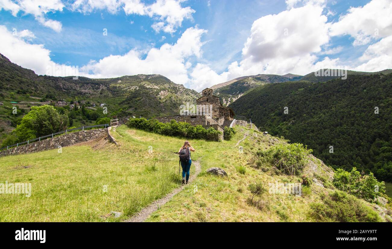 A young tourist woman during the hike in the Pyrenees mountains. On her ...