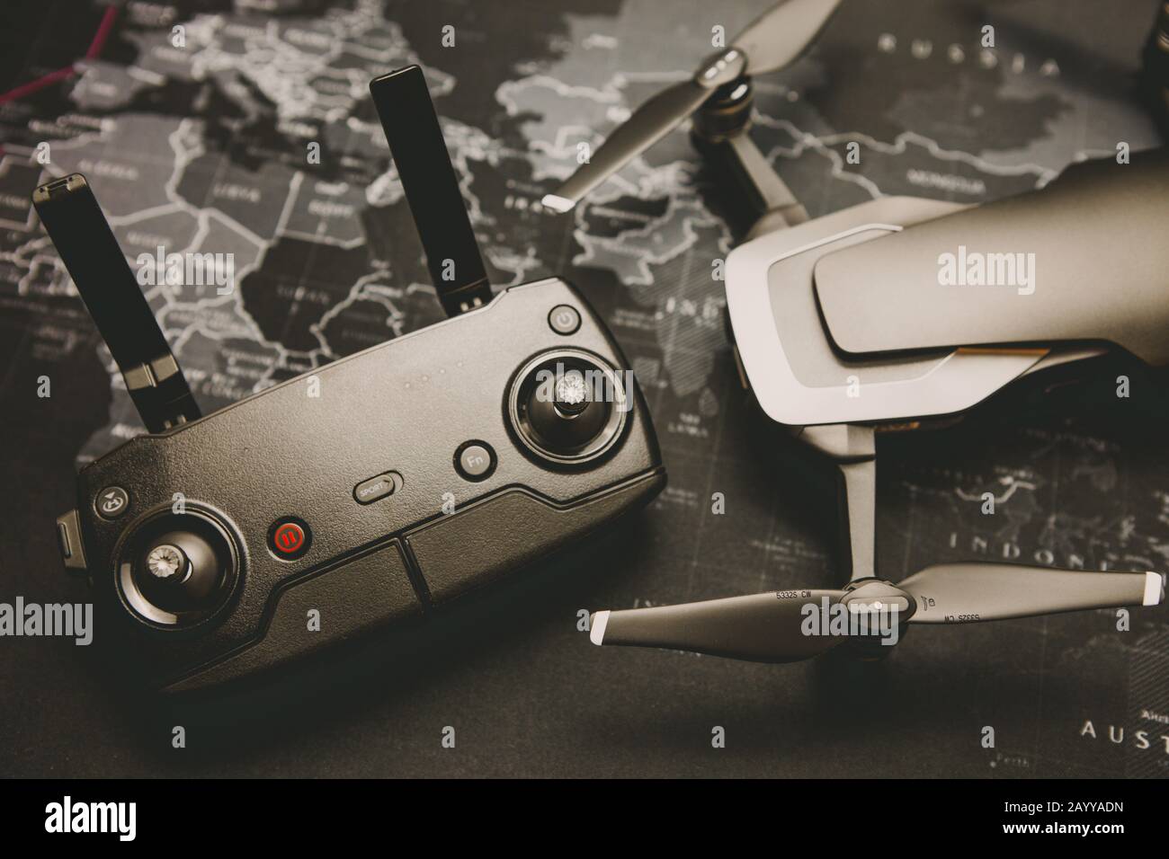 Drone copter with remote controller on world map background, close-up ...
