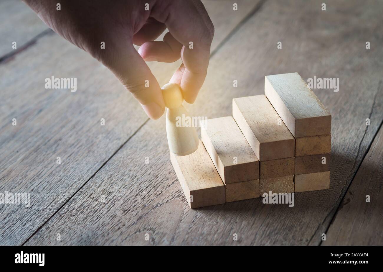 human hand grab wooden dolls to up stair made from wooden block Stock ...