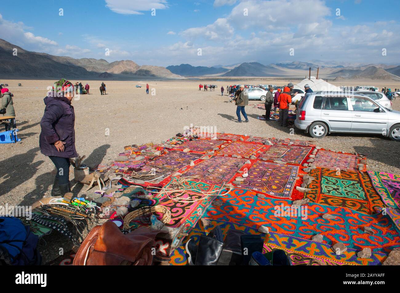 A vendor selling rugs and other goods at the Golden Eagle Festival ...