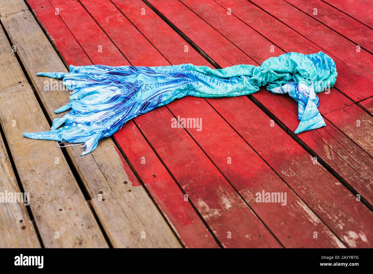 Mermaid swimming suit set to dry on wooden floor Stock Photo - Alamy