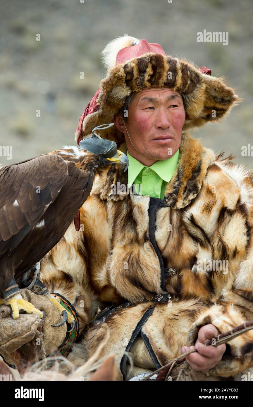 Portrait of Kazakh eagle hunter at the Golden Eagle Festival on the ...