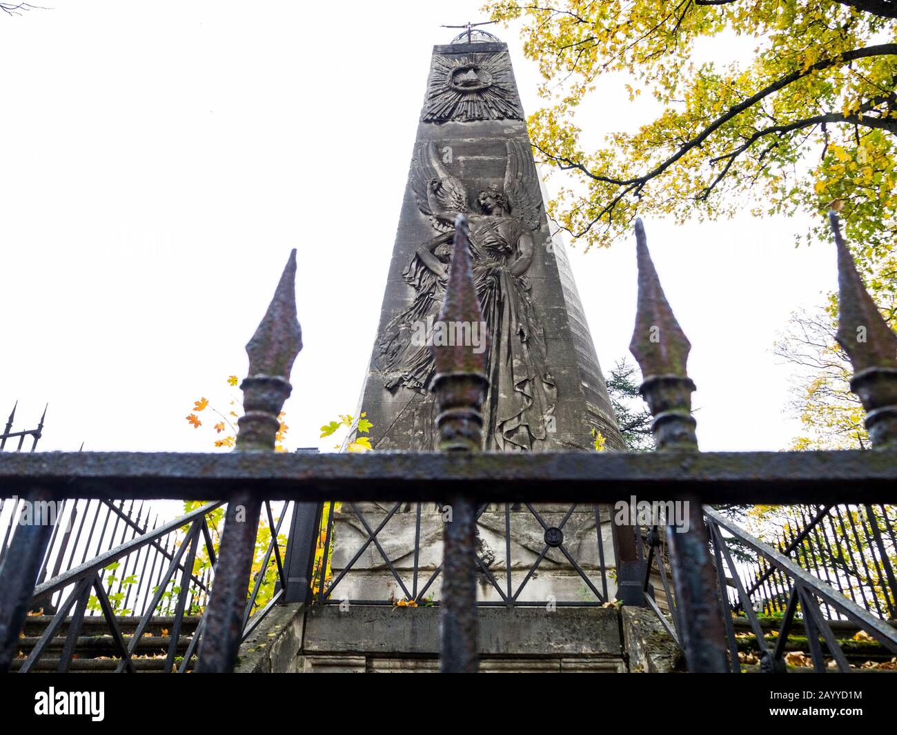 Old tombstone with a square pillar depicting an angel and the Holy ...