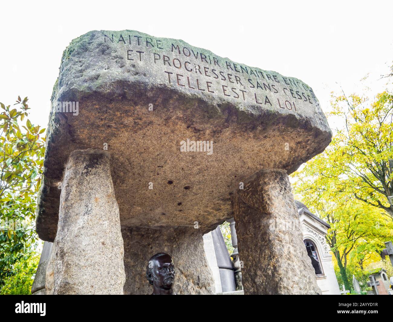Detail of a funeral monument made of white stone and a metal head with ...