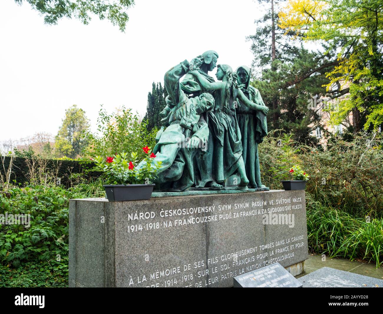 Funeral monument of grey stone with a group of statues made of four ...