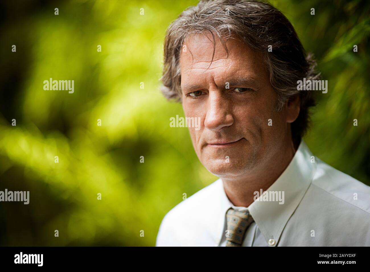 Mature businessman poses for a portait outside Stock Photo - Alamy