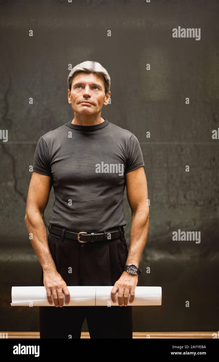 Portrait of architect holding blueprints Stock Photo - Alamy
