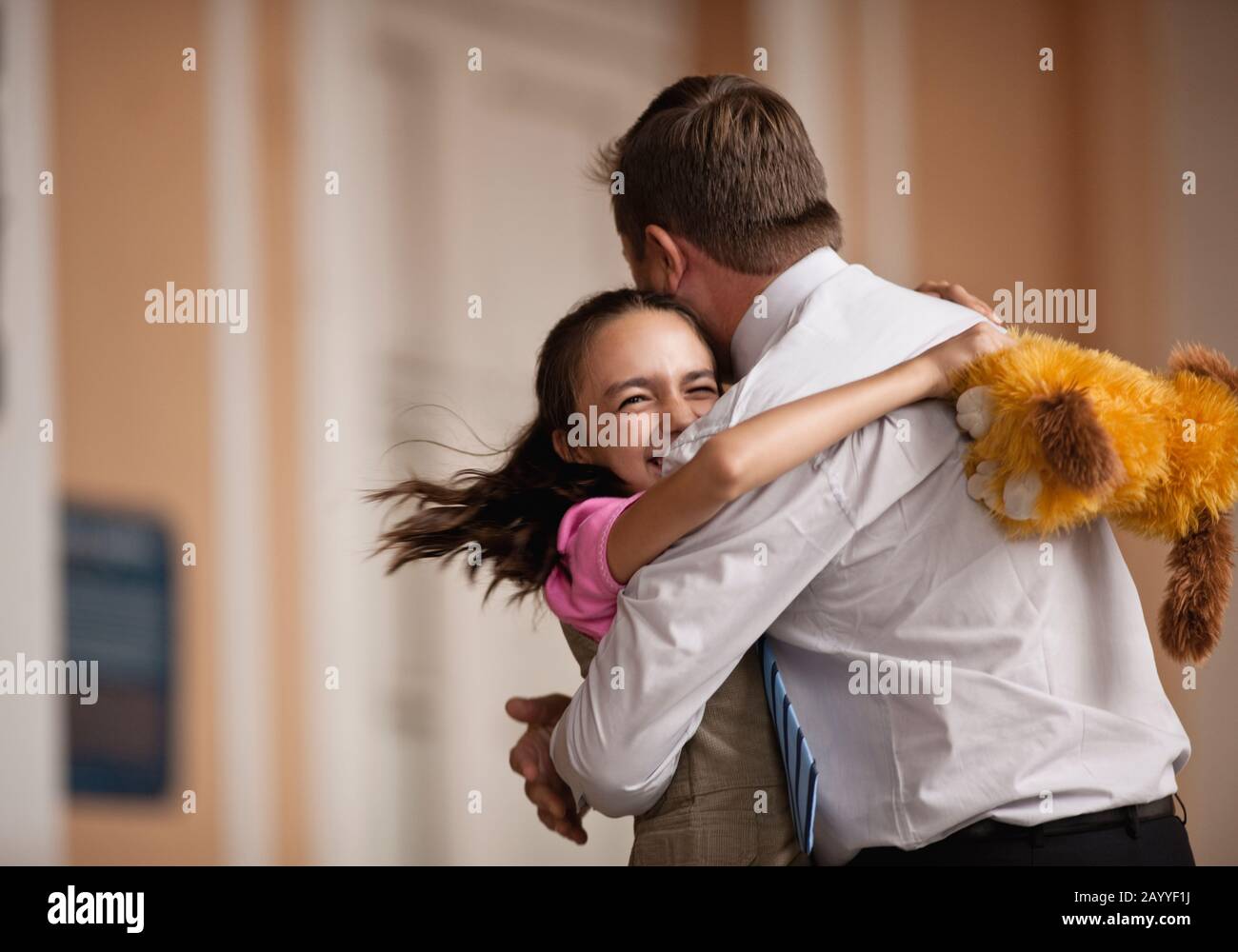 Man happily hugging his daughter Stock Photo - Alamy