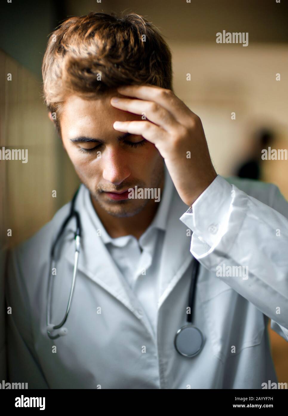 Young doctor with headache Stock Photo - Alamy