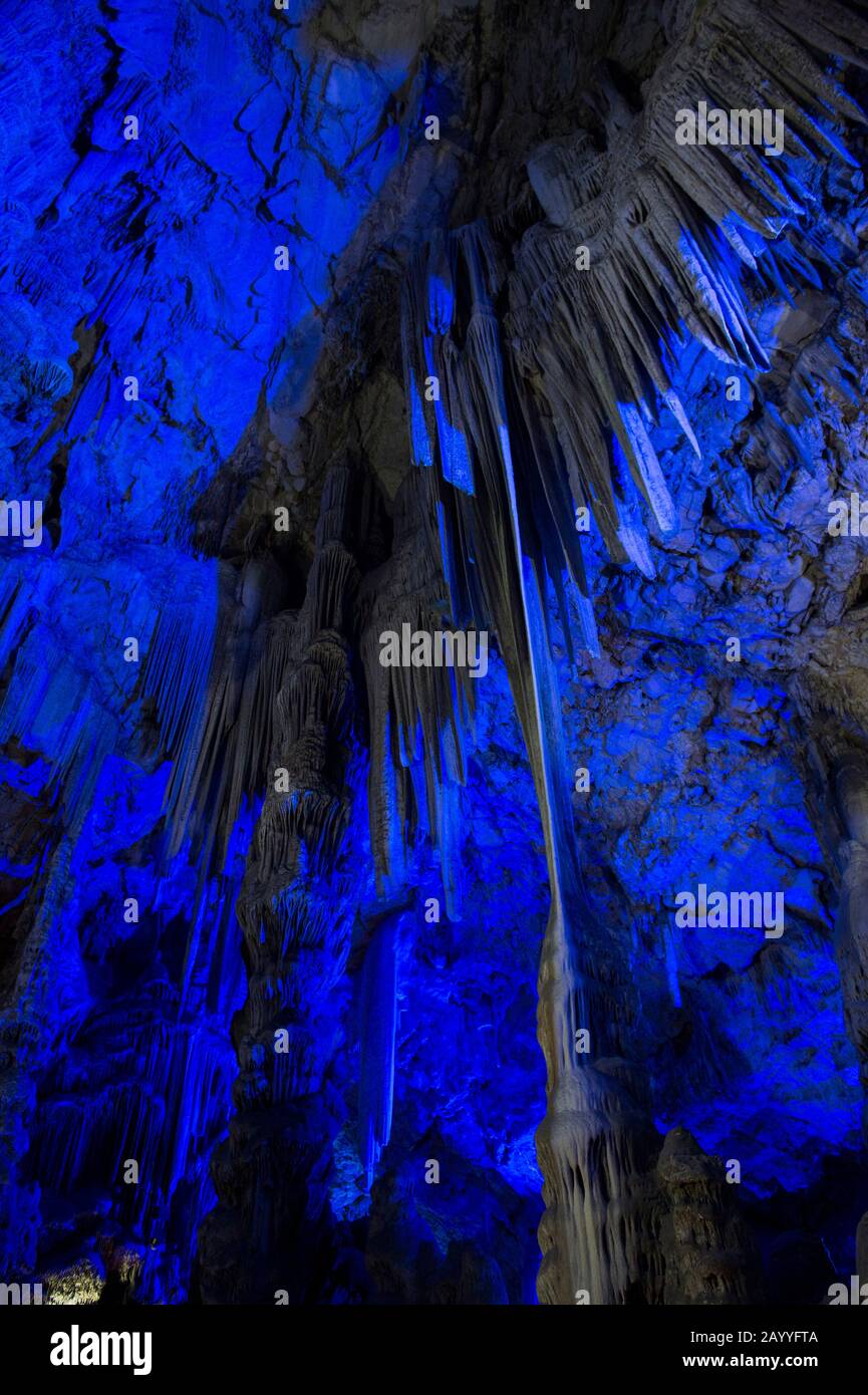 Colorful lights illuminate the stalactites and stalagmites in the St ...