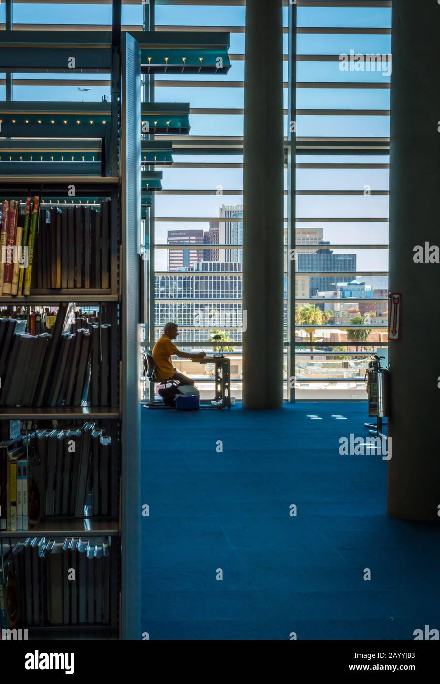 Man reading by a glass window at Burton Barr Central Library in ...
