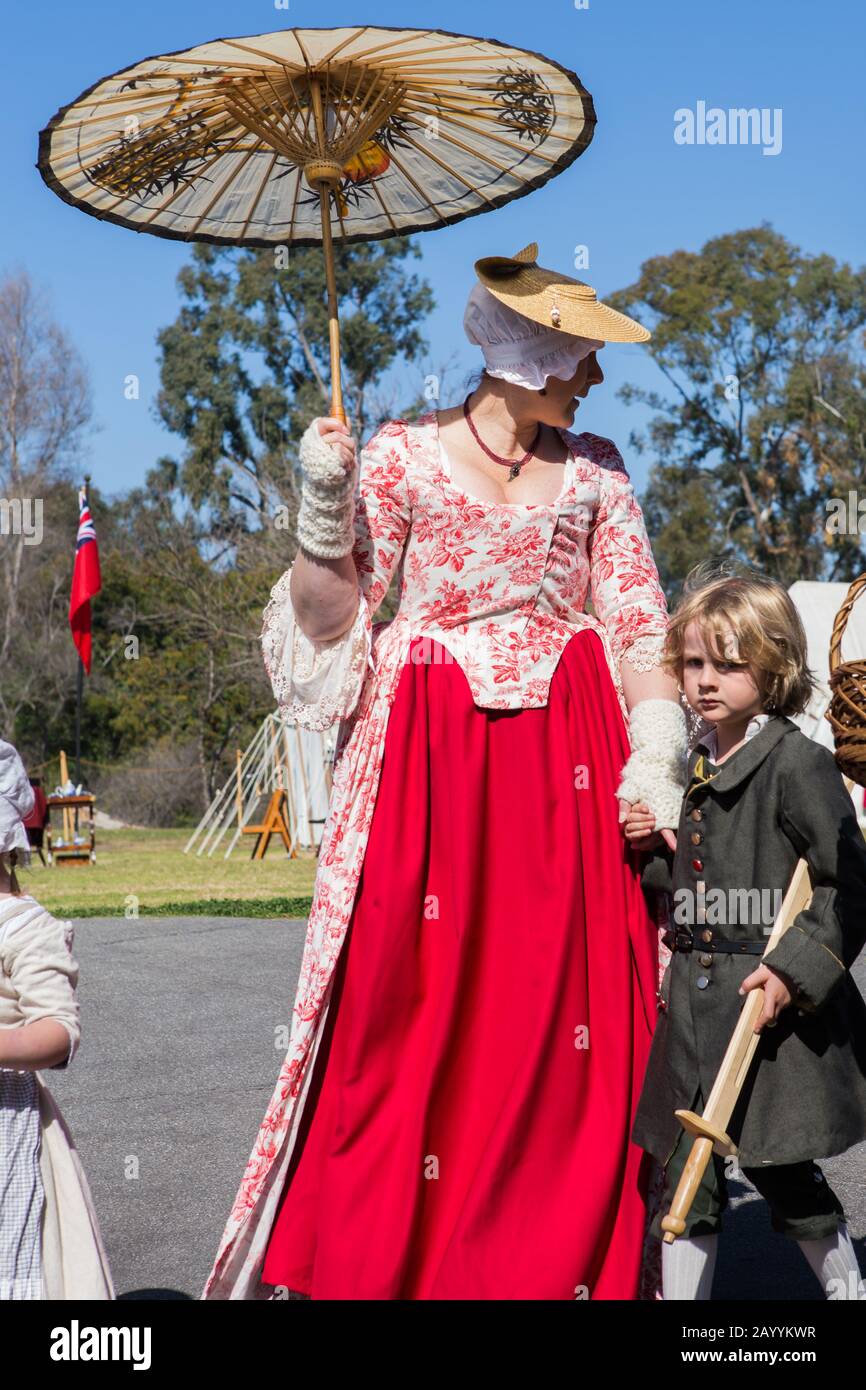 Women in historic costume carrying a parasol at a American Revolution ...