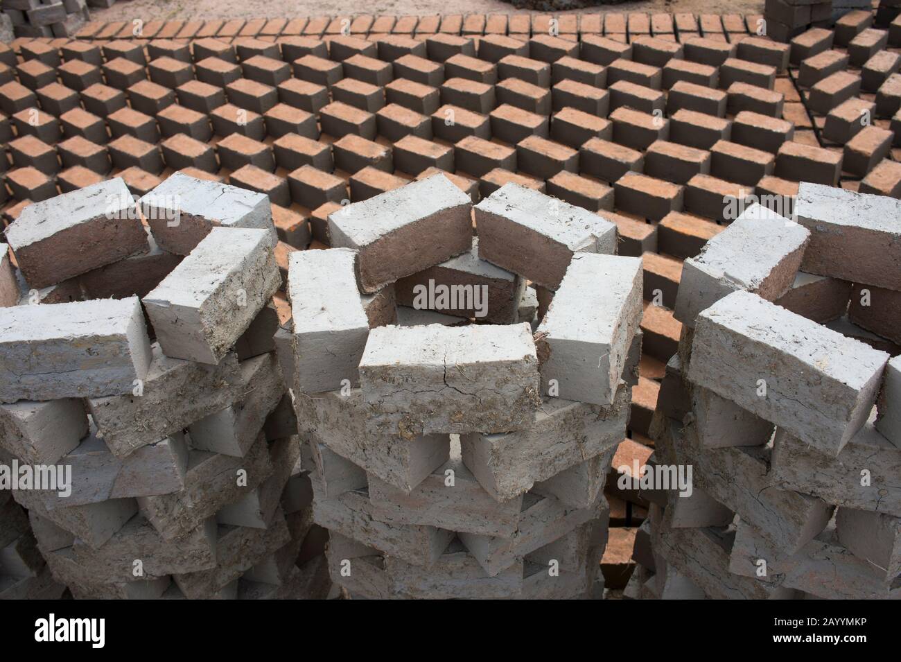 Bricks made out of clay are drying on air on the outskirts of ...