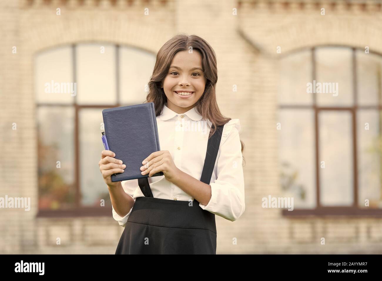 With library you are free. Happy small child hold library book with ...