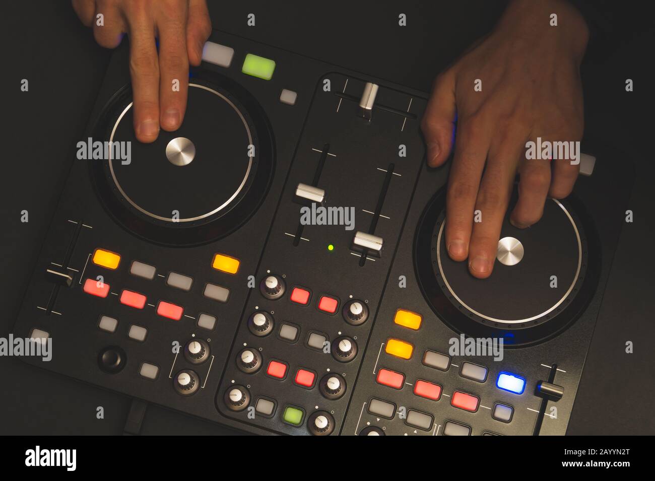 DJ plays music. sound mixer controller with knobs and sliders close up ...