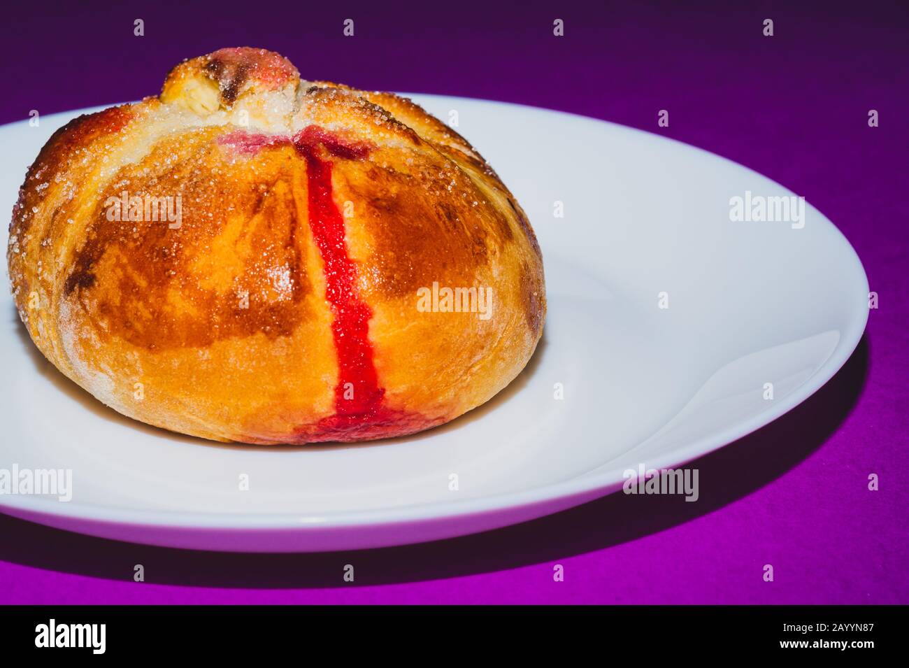 Bun with red sweet jam inside. sweet baking close up Stock Photo - Alamy