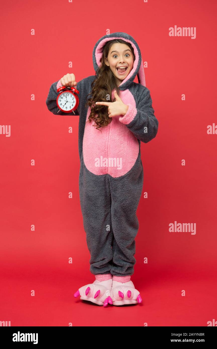 Counting time. It is weekend. Adorable bunny hold alarm clock. Small ...