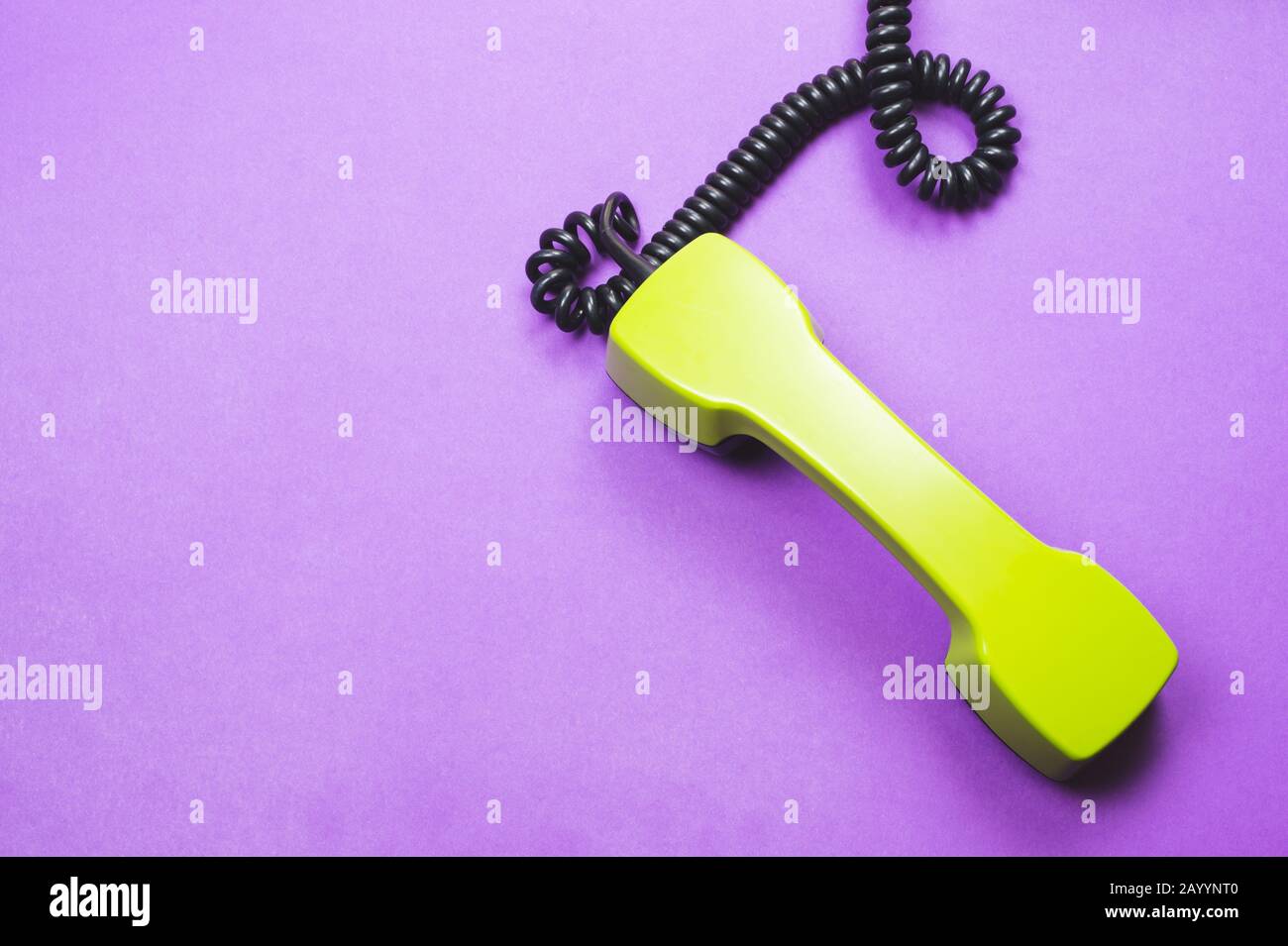 Vintage green telephone handset. phone receiver isolated on purple ...