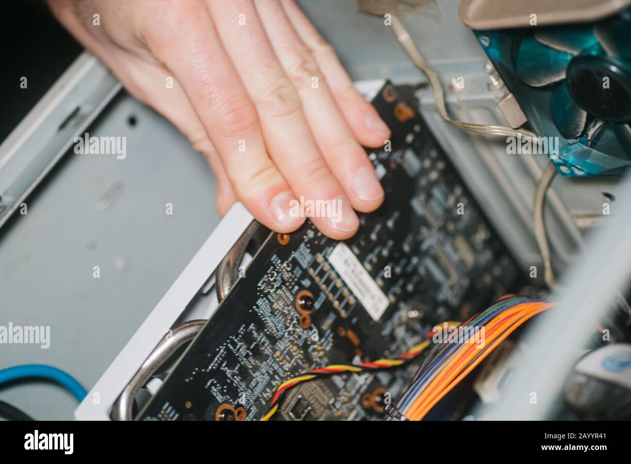 Professional man repairing and assembling computer inside. Male hand ...