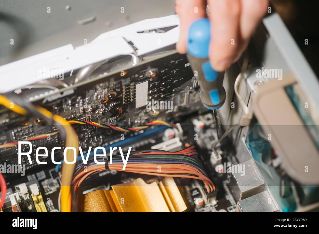 Text RECOVERY. Installing motherboard with screwdriver. Professional ...