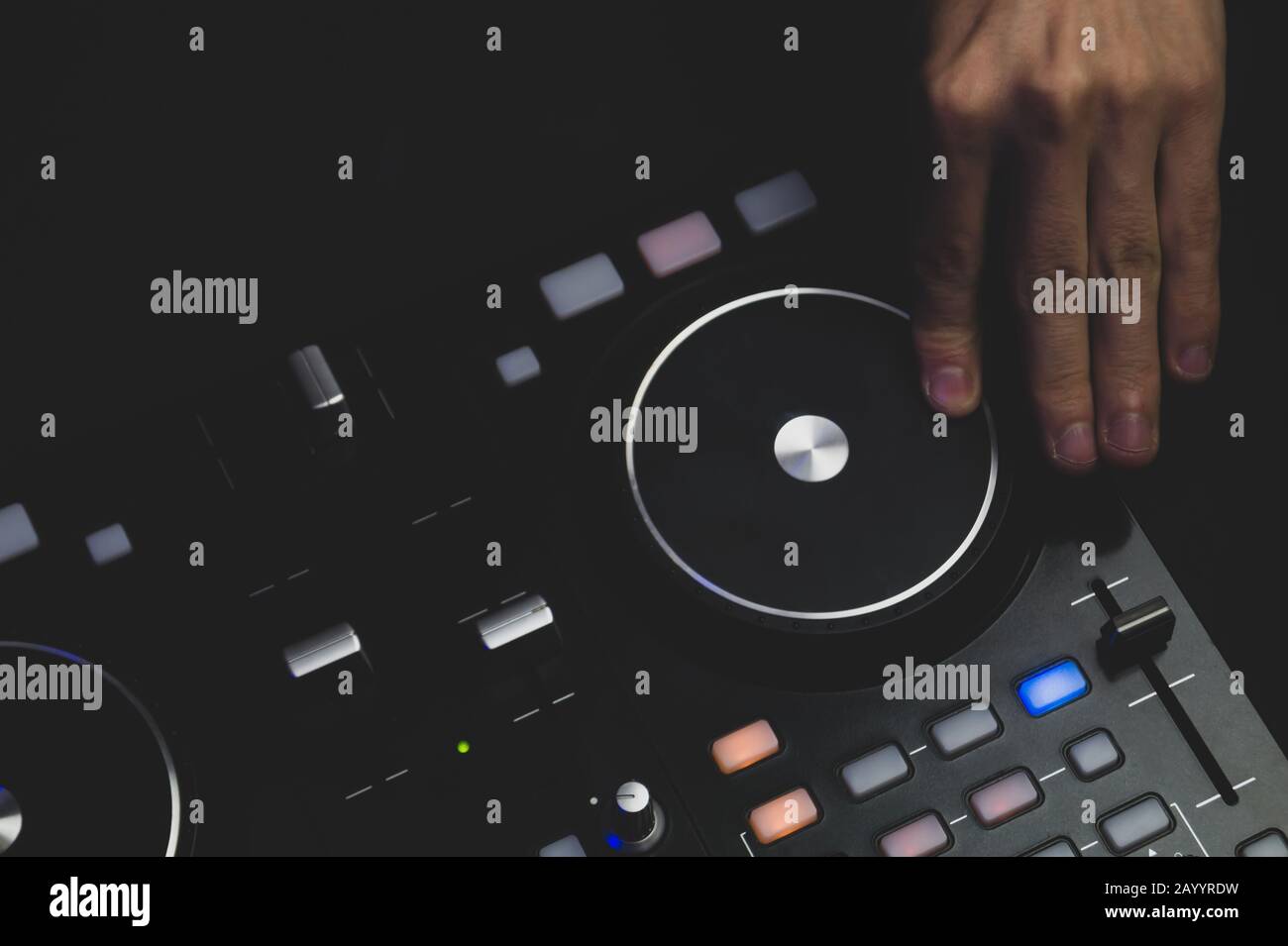 DJ plays music. sound mixer controller with knobs and sliders close up ...