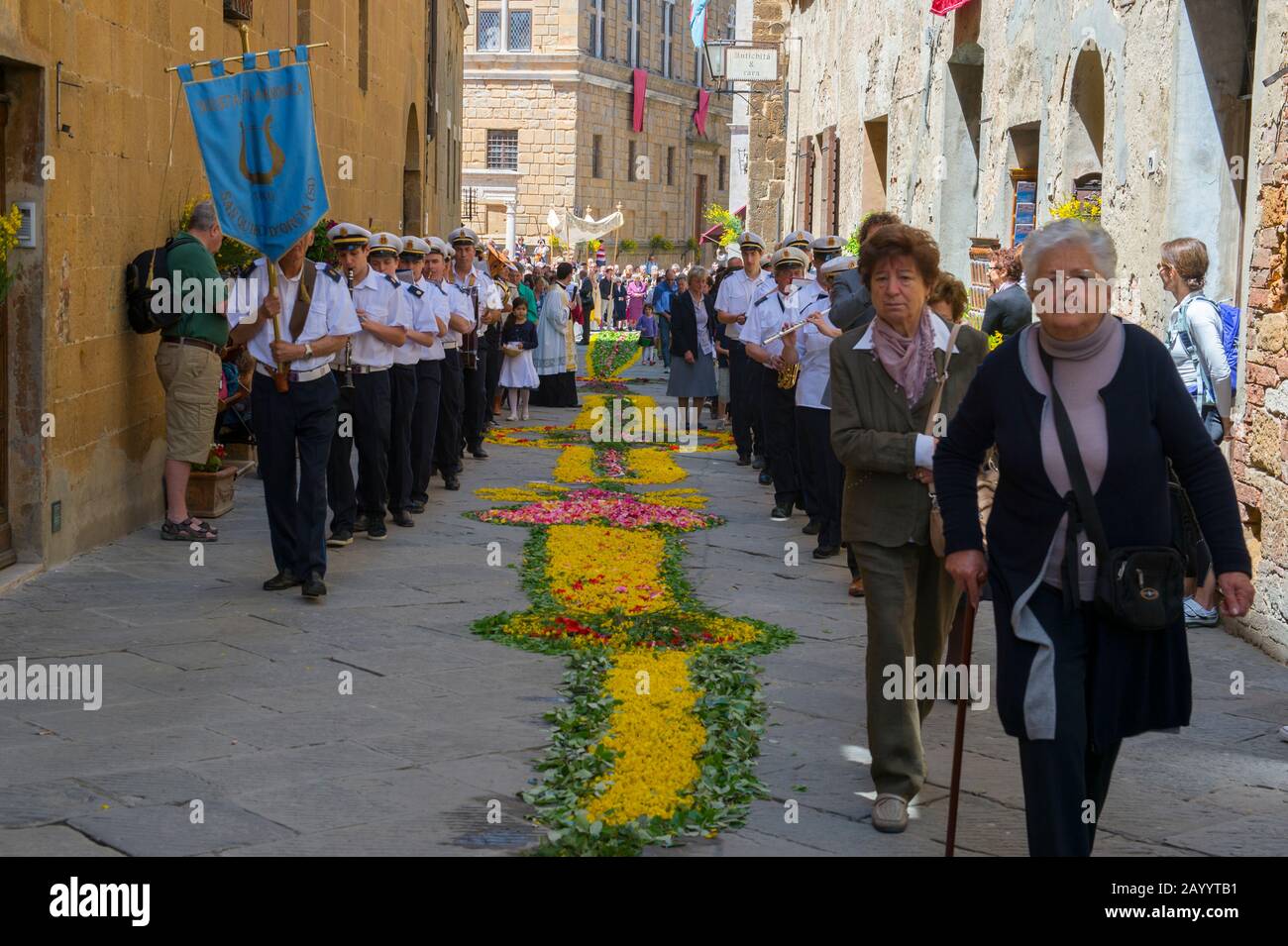 Procession with music band in street decorated with flowers for the ...