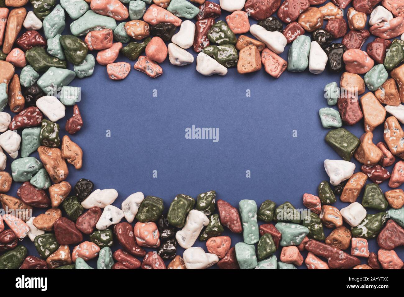 Candy pebbles. sweets in the form of colored stones. frame made from ...