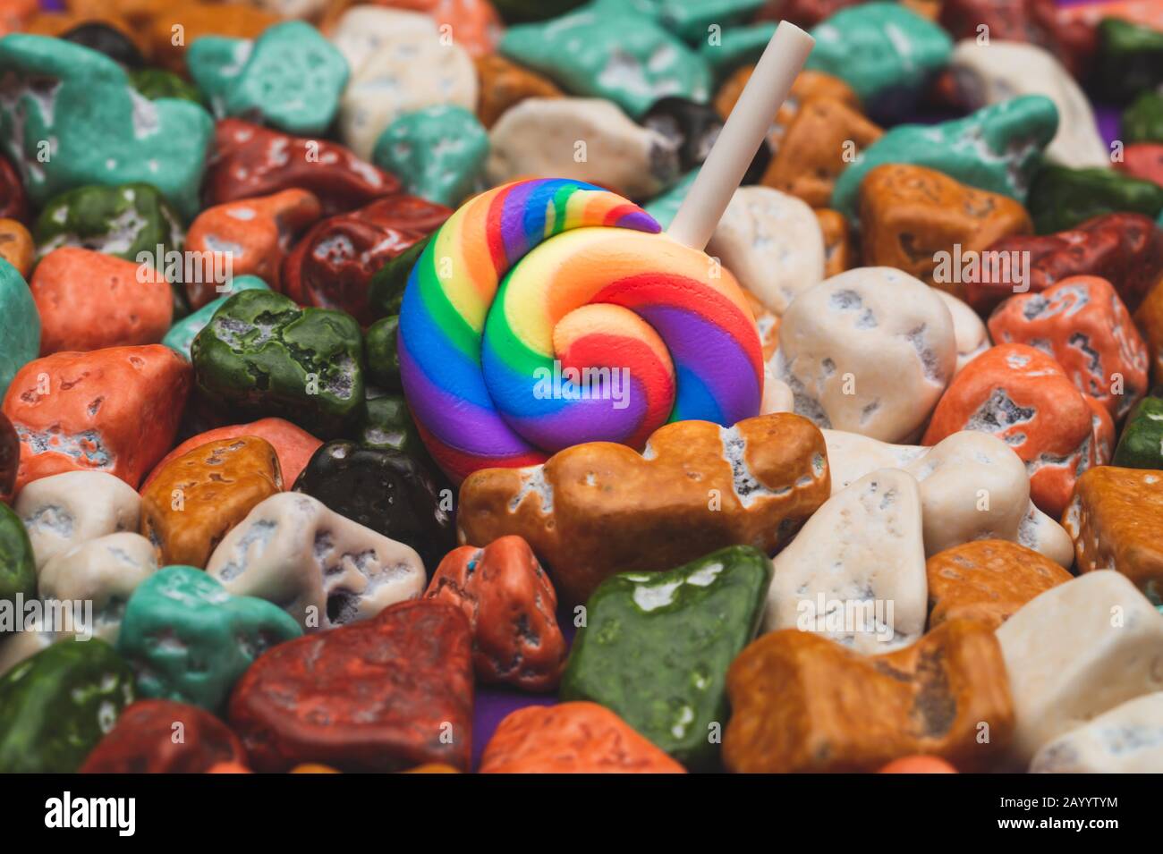 Lollipops and candy pebbles. spiral candies and sweets in the form of ...