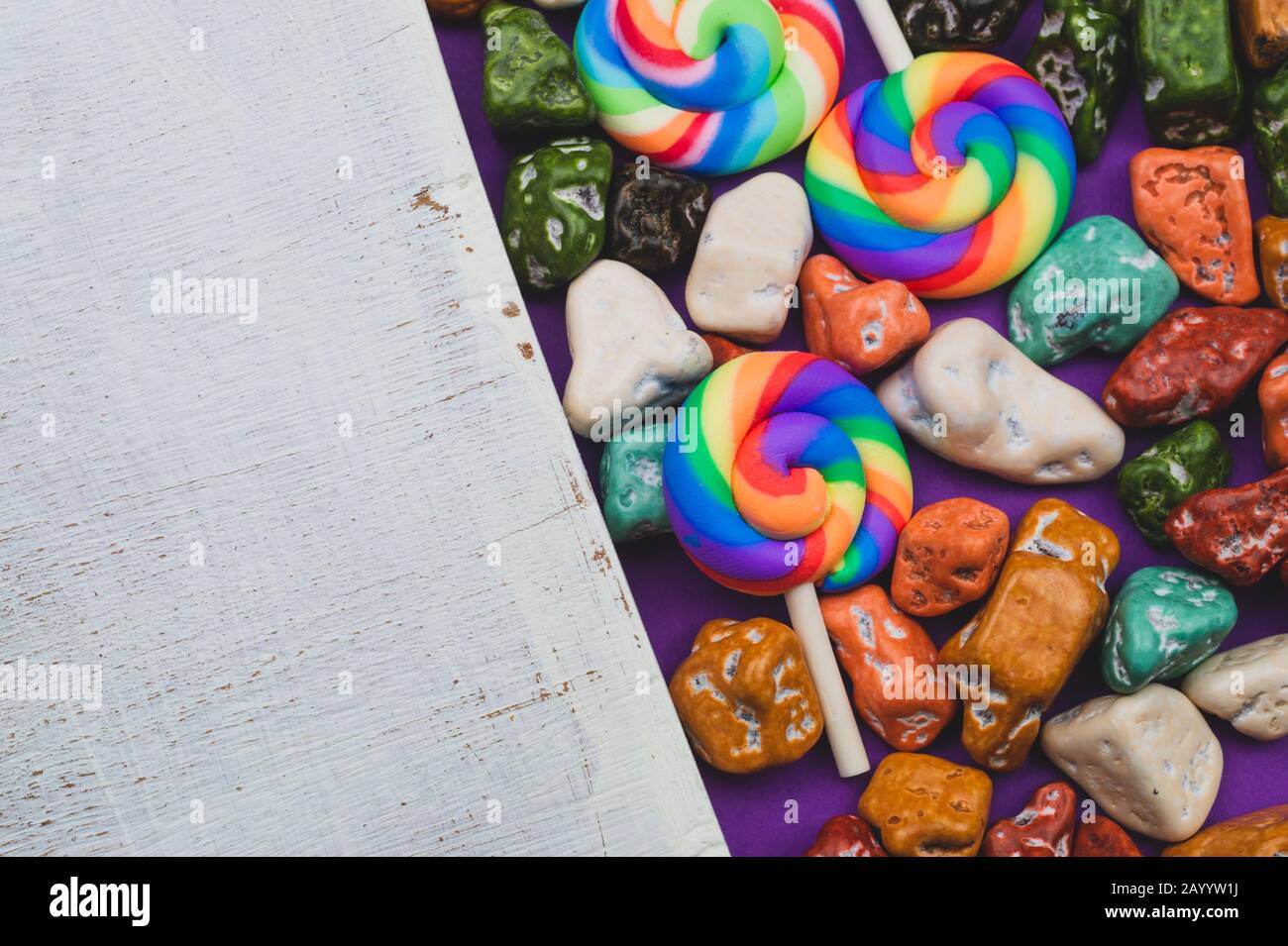 Lollipops and candy pebbles. sweets in the form of colored stones ...