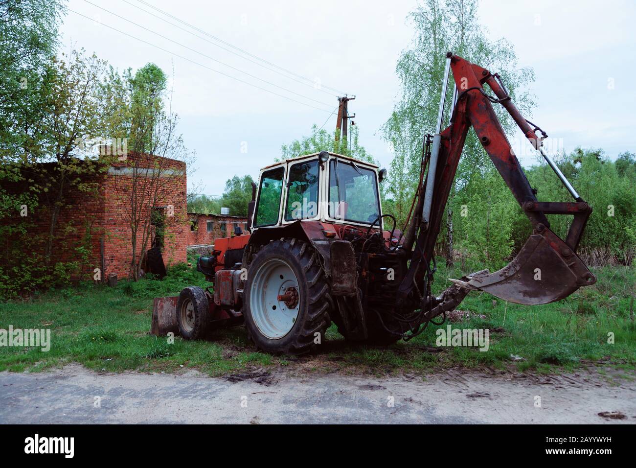 red old rusty tractor in a field near road Stock Photo - Alamy