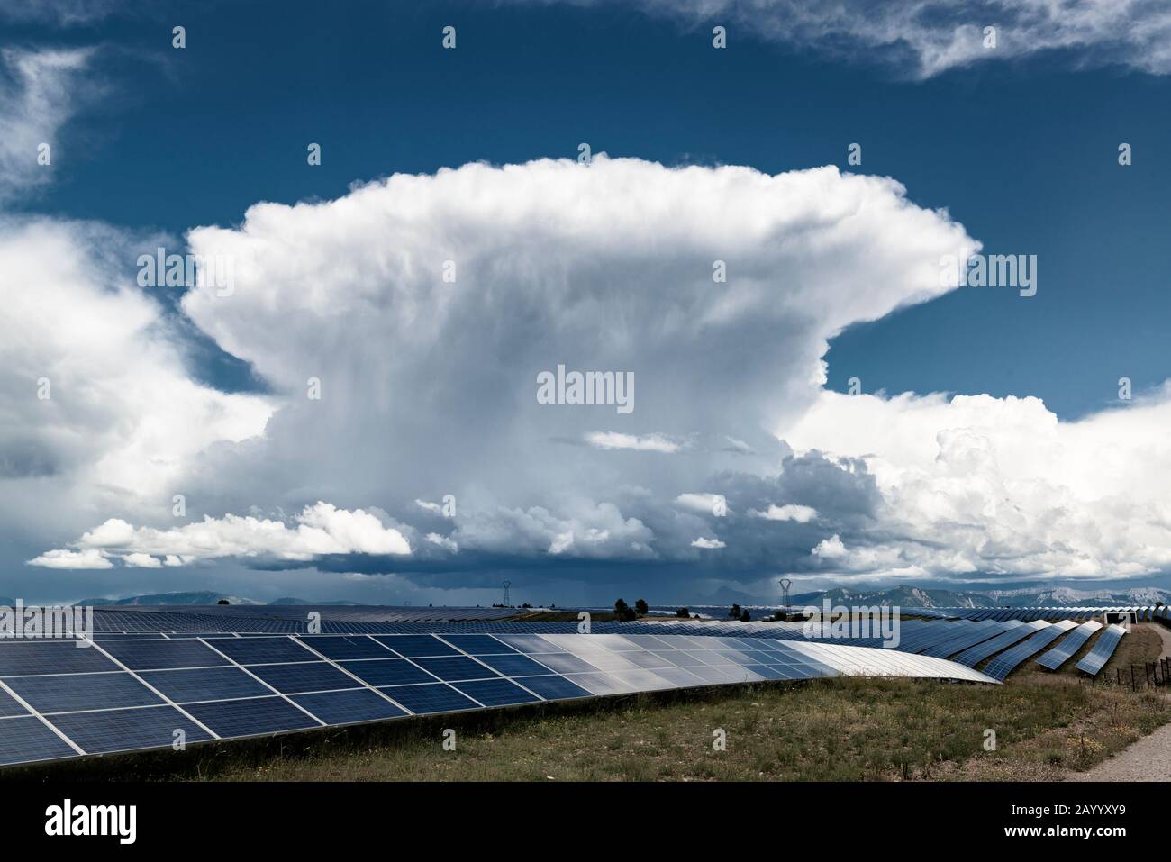 Power of nature. Solar power plant and big growing thunderstorm cloud ...