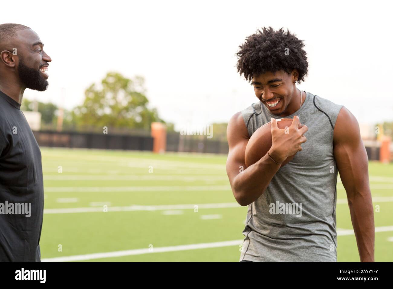 American Football coach training a young athlete Stock Photo - Alamy