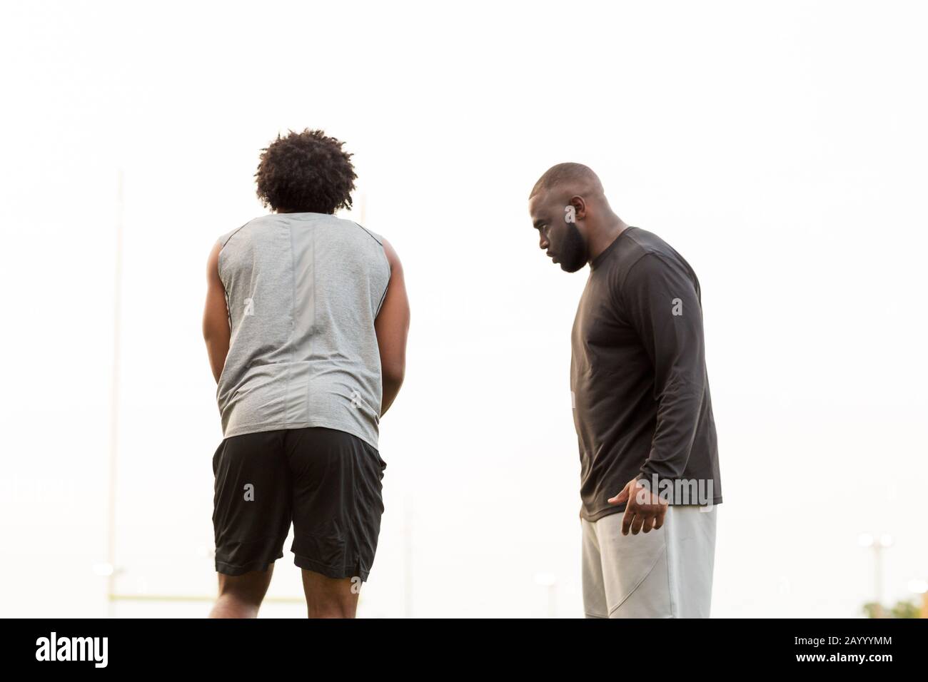 American Football coach training a young athlete Stock Photo - Alamy