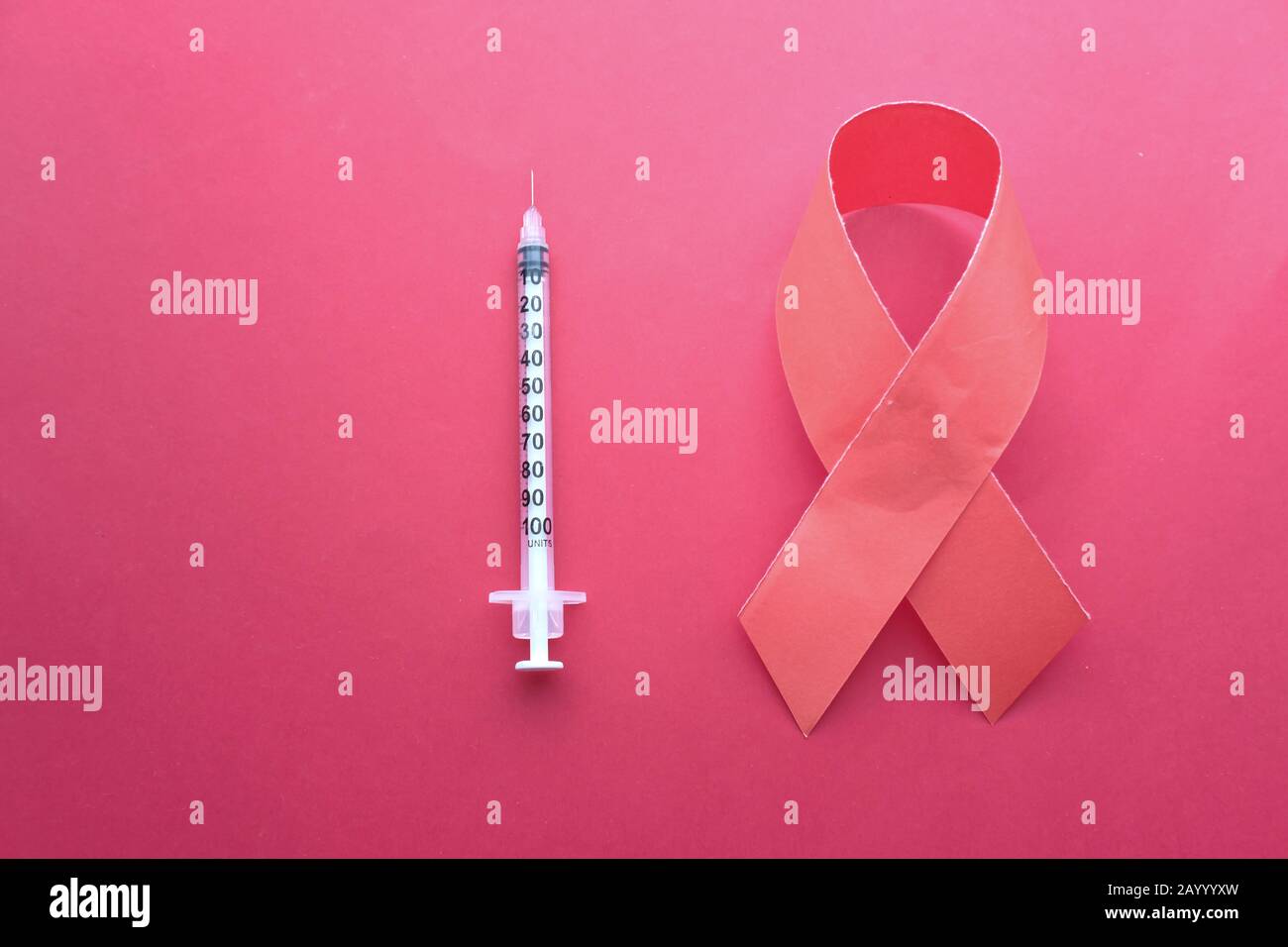 HIV concept with syringe on red background Stock Photo - Alamy