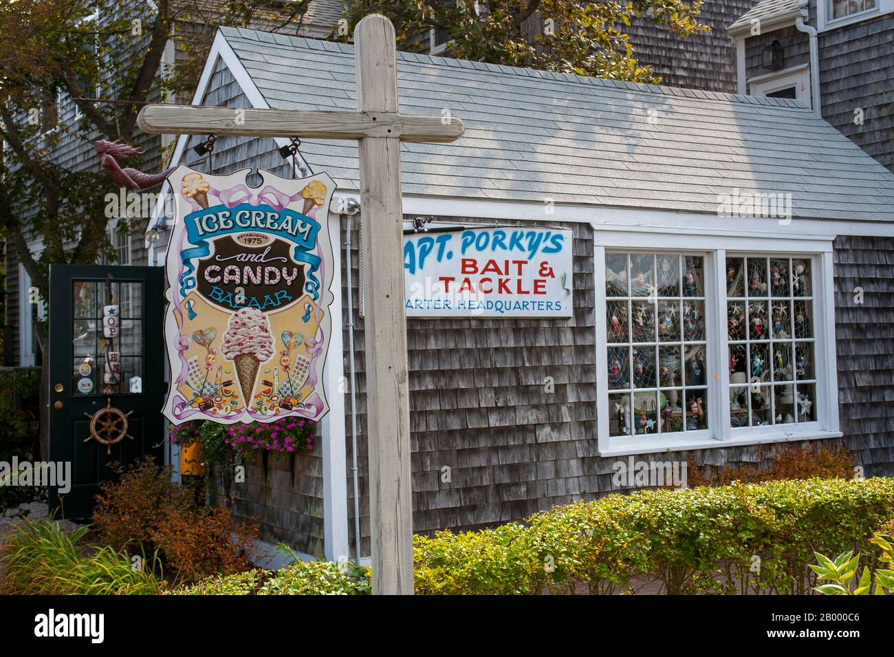 A street scene with a colorful ice cream and candy store sign in ...