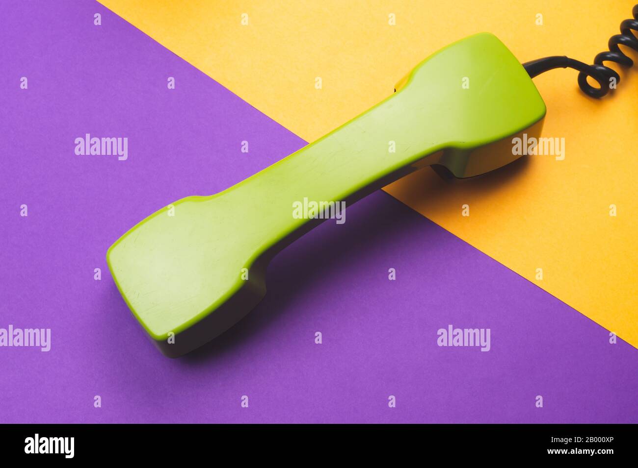 Vintage green telephone handset. phone receiver on color background ...