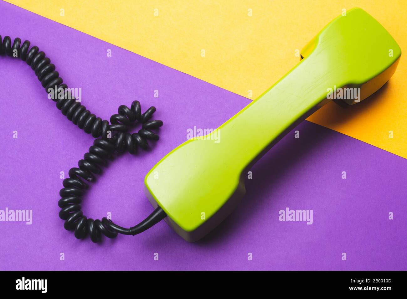Vintage green telephone handset. phone receiver on color background ...