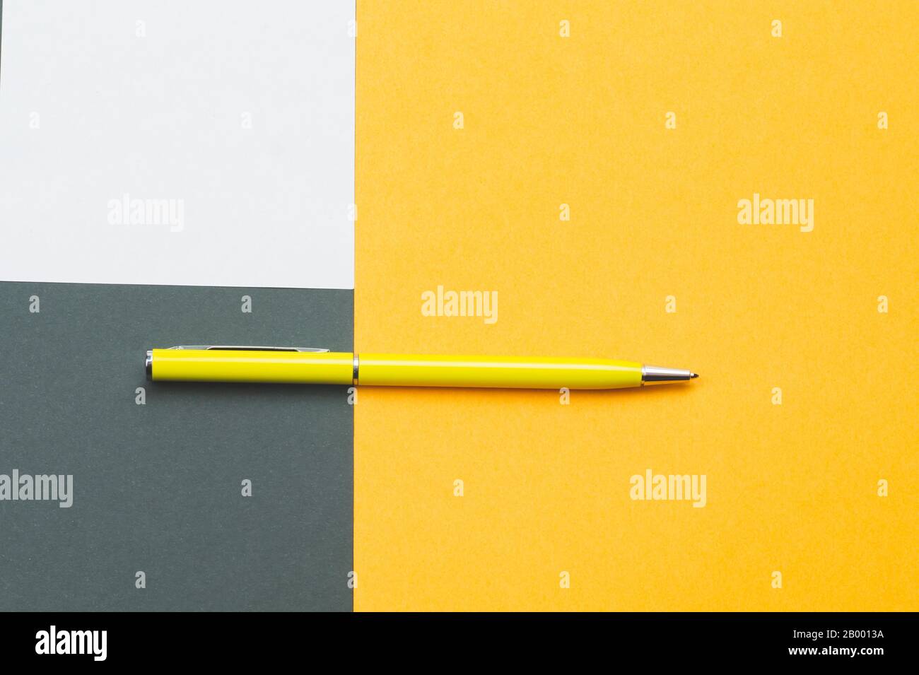 Yellow pen and white note on colored background Stock Photo - Alamy