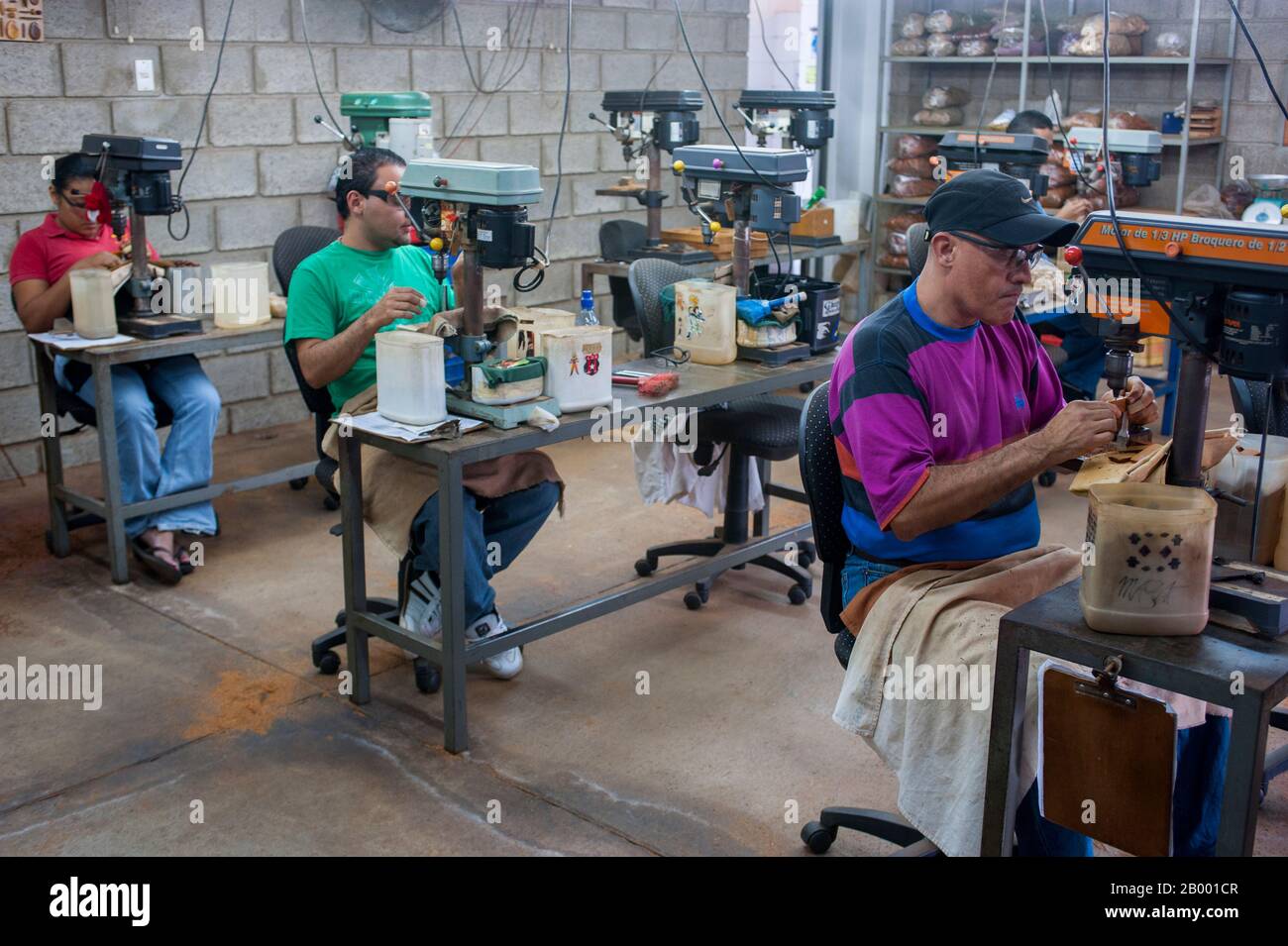Workers producing wooden souvenirs at the Sr y Sra Ese Wooden Souvenir ...