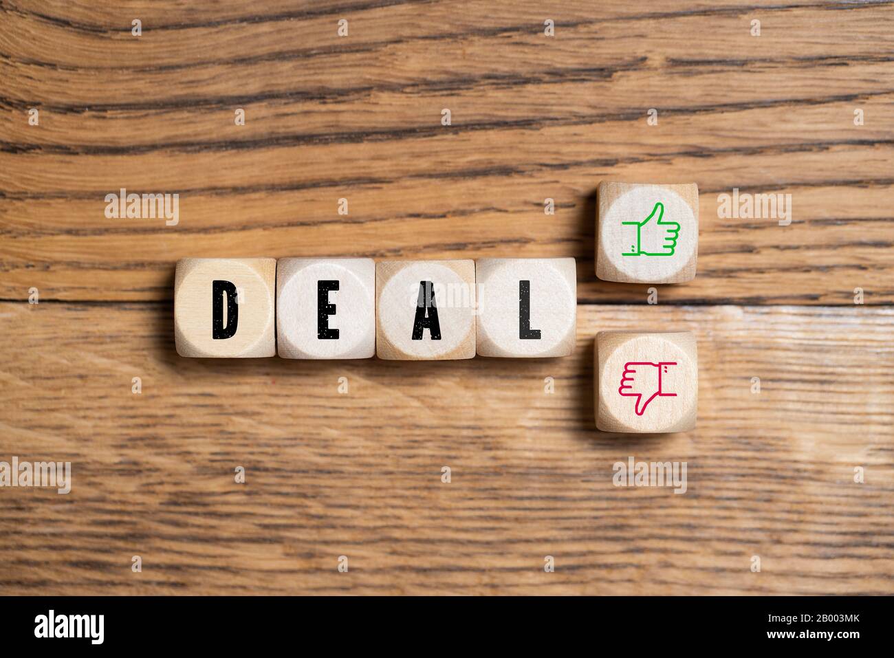 wooden blocks with the word "deal" and thumbs up and down icons ...