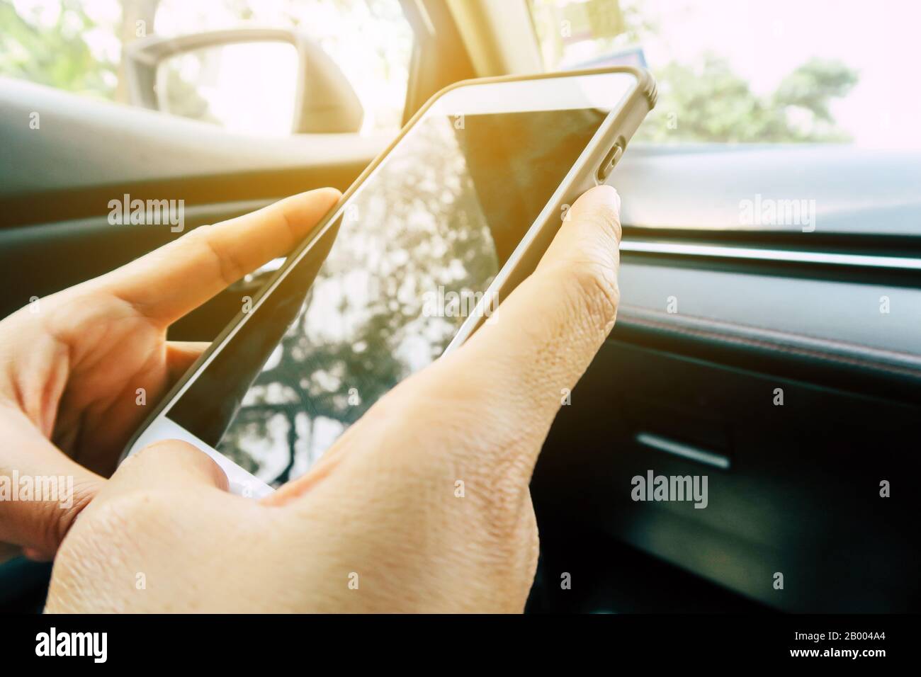 image of people using a smartphone inside of a car Stock Photo - Alamy