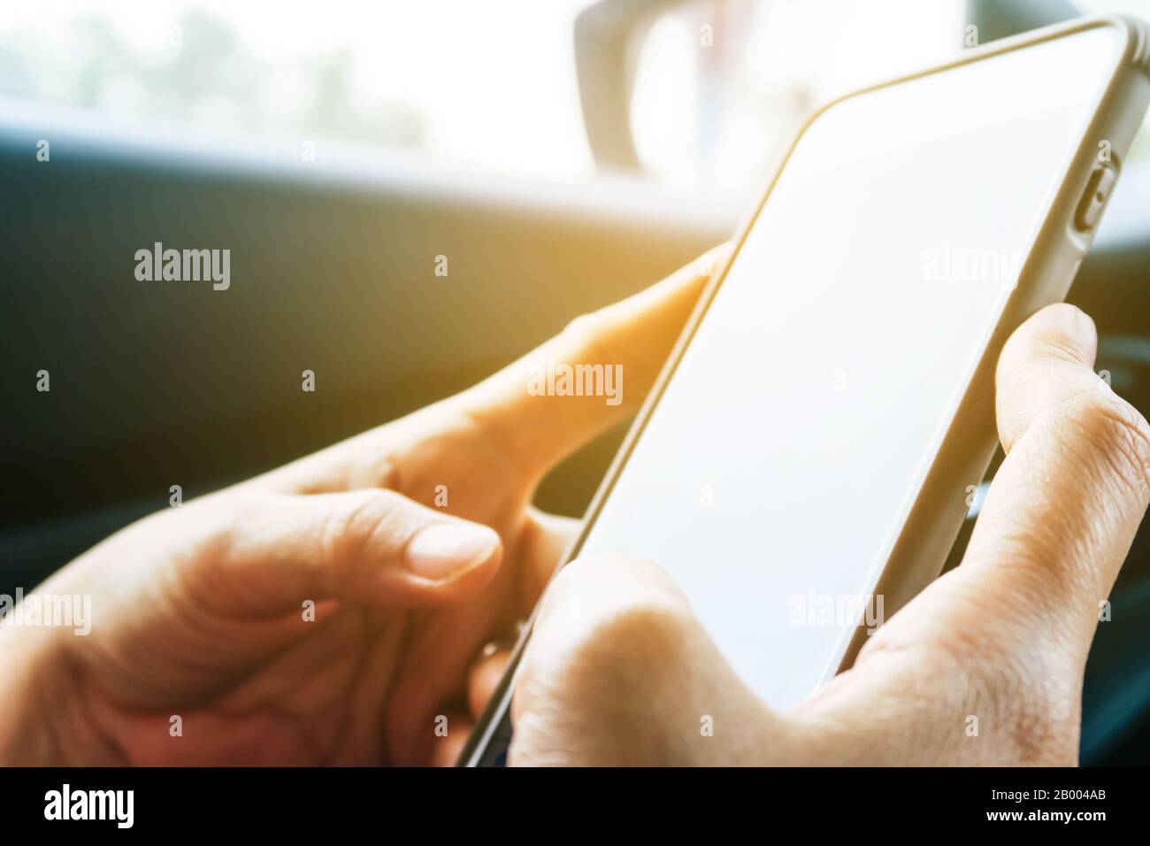 image of people using a smartphone inside of a car Stock Photo - Alamy