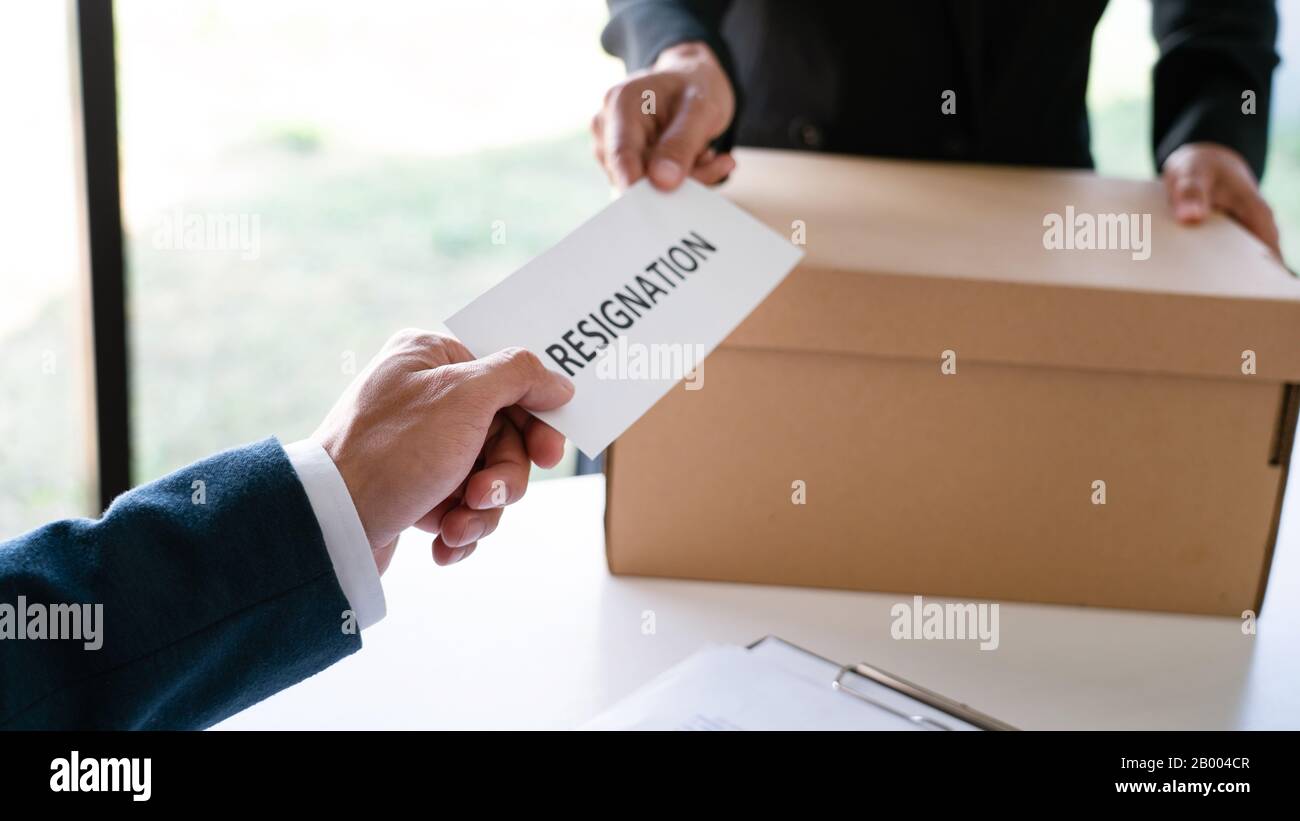 Businessman Sending Resignation Letter To The Executive Employer Boss On Desk In Order To Resign businessman-sending-resignation-letter-to-the-executive-employer-boss-on-desk-in-order-to-resign