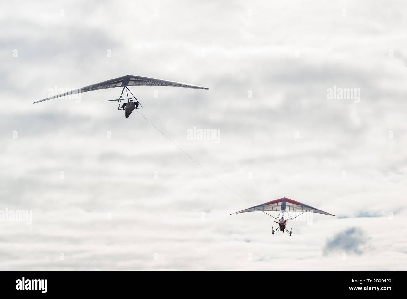 Motorized hang glider tows another wing. Hang glider aerotowing Stock ...